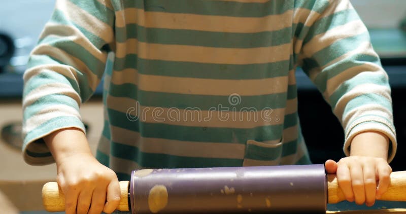 A Little Girl Makes Cookies at Home Using the Rolling Pin Stock Photo ...
