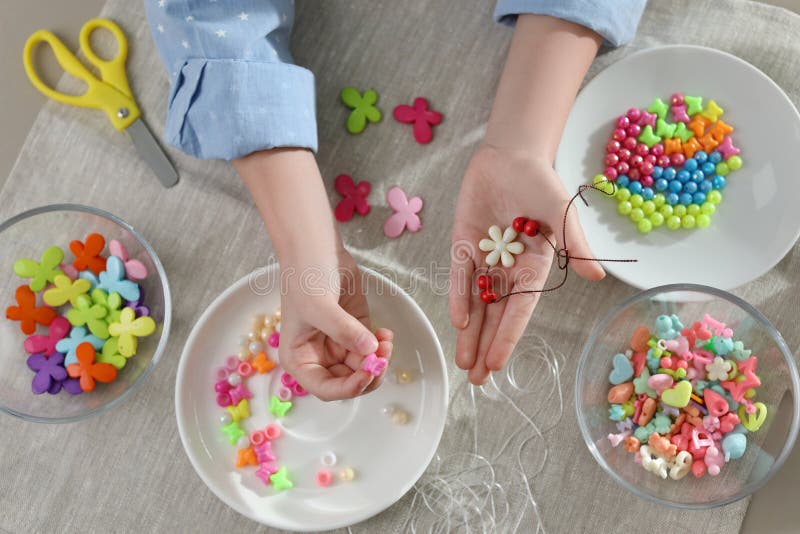Little Girl Making Accessory with Beads at Table. Creative Hobby Stock ...