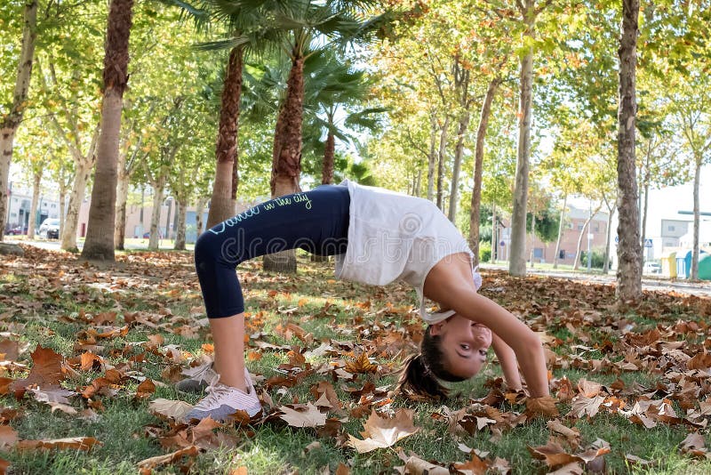Little Girl Making the Bridge in a Park in Autumn Stock Photo - Image ...