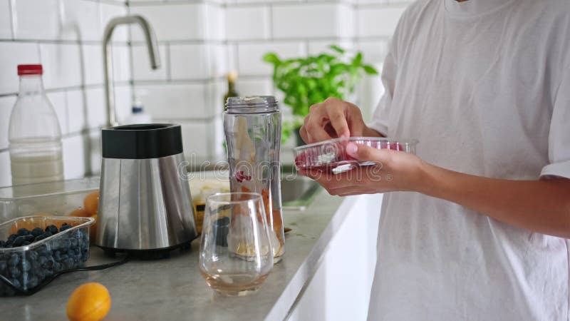 Little Girl Making a Milkshake Adding Raspberry To the Fruit Shake ...
