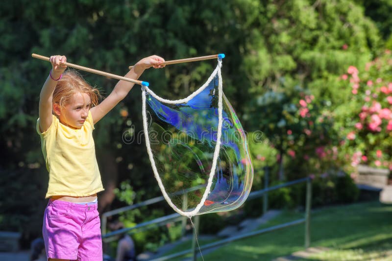 Little Girl Making Rope Bubbles Stock Image - Image of park, outdoors ...