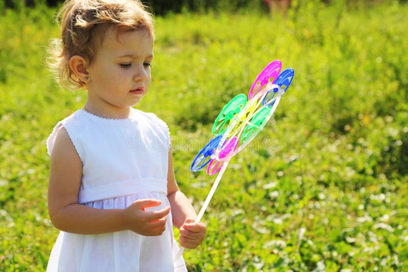 The Little Girl with the Motley Pinwheel Stock Image - Image of casual ...
