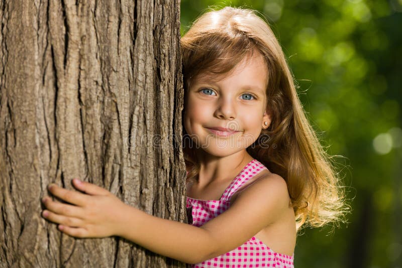 Little girl near a tree stock photo. Image of childhood - 33036526