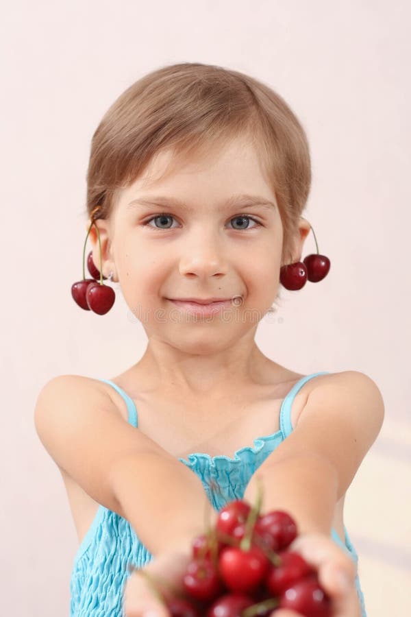Little Girl Offering a Handful of Cherries Stock Photo - Image of ...