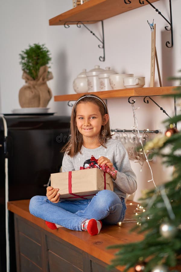 Little Girl Opens a Box with a Christmas Present from Santa Stock Image ...