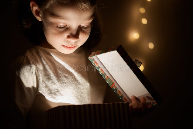A Little Girl Opens a Glowing Gift Box Stock Photo - Image of open ...