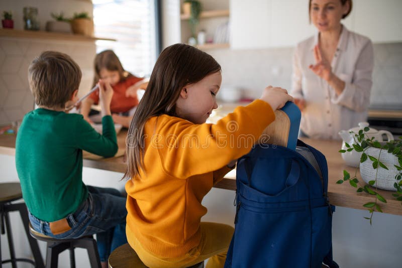 Little Girl Packing Lunch Box To Backpack in Kitchen at Home. Stock ...