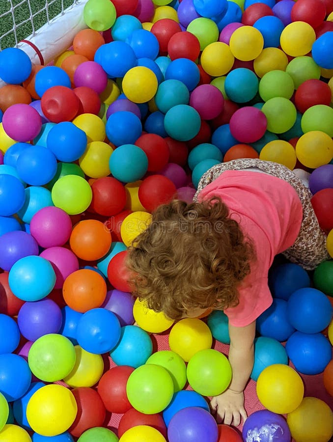 Little Girl in Park of Colored Balls Editorial Stock Photo - Image of ...