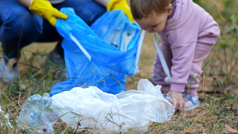 Little Girl Picks Up Trash Helping To Save Environment Stock Photo ...