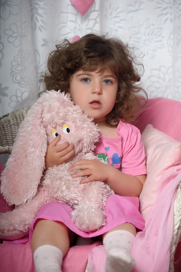 Little Girl with a Pink Rabbit Stock Image - Image of eyes, chair: 34134513