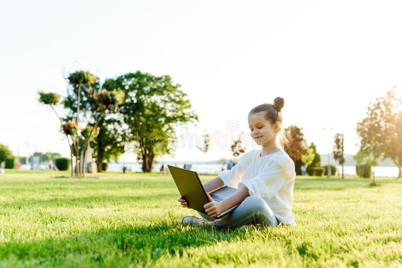 Little Girl Play Computer on Green Grass Stock Image - Image of outside ...