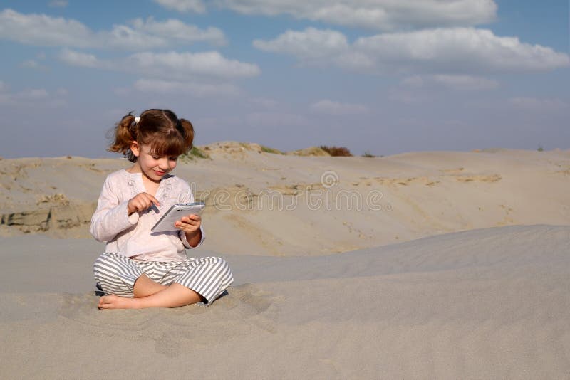 Little Girl Play with Tablet Pc in Desert Stock Image - Image of device ...