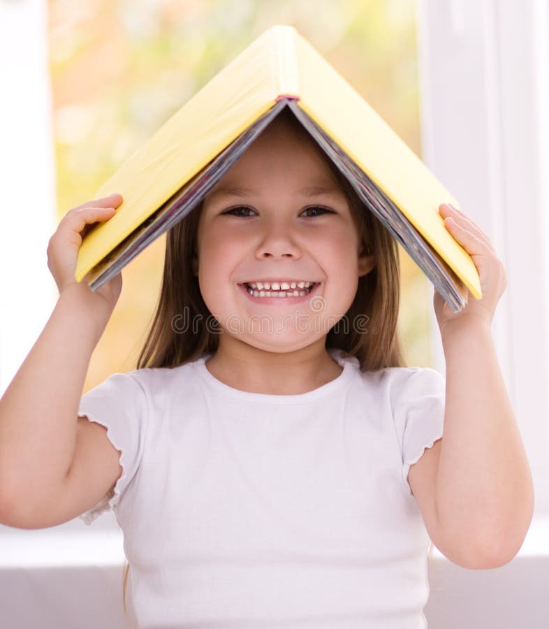 Little Girl is Playing with Book Stock Photo - Image of brunette ...