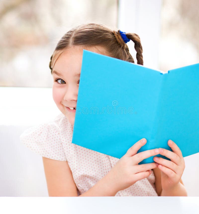 Little Girl is Playing with Book Stock Photo - Image of brunette ...
