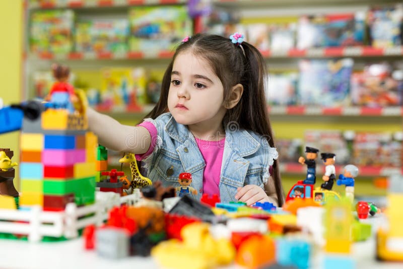 Little Girl Playing with Building Blocks in the Store. Stock Image ...