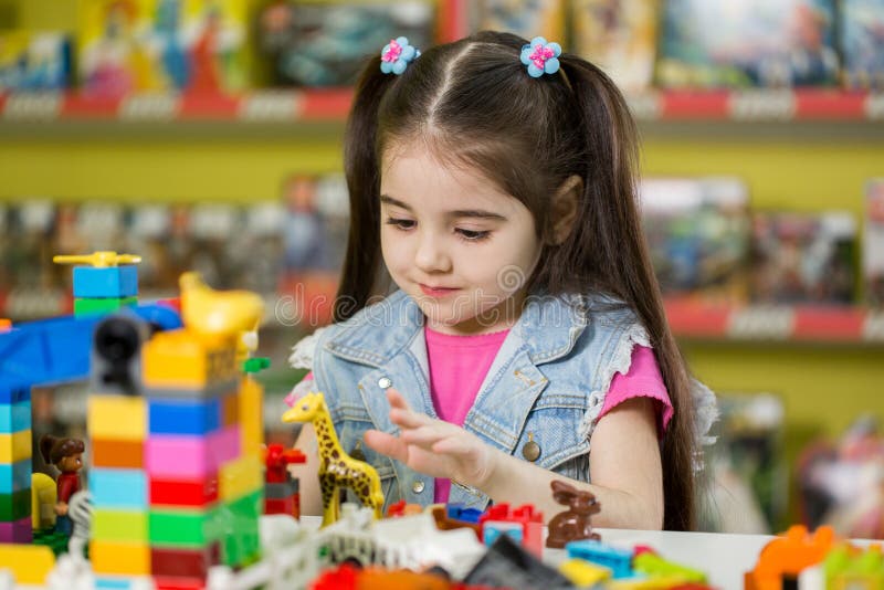 Little Girl Playing with Building Blocks in the Store. Stock Image ...