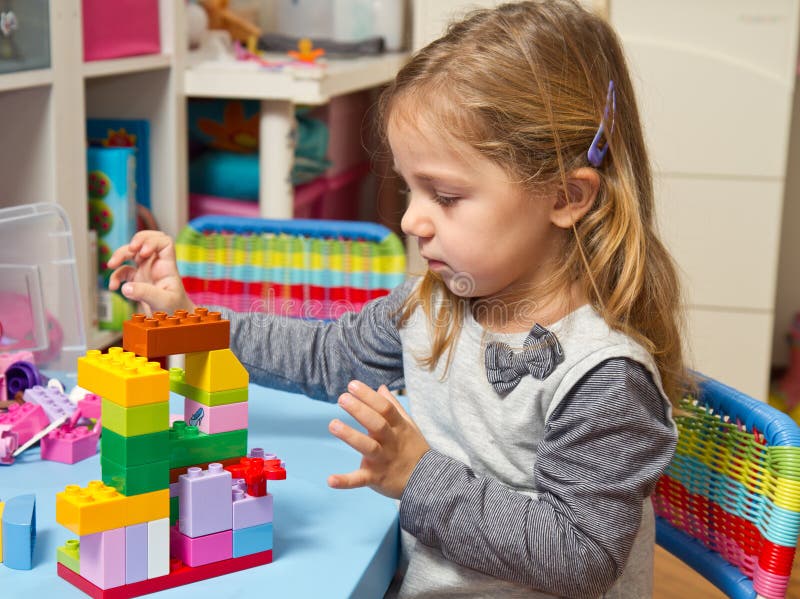 Little Girl is Playing with Building Bricks Stock Image - Image of ...