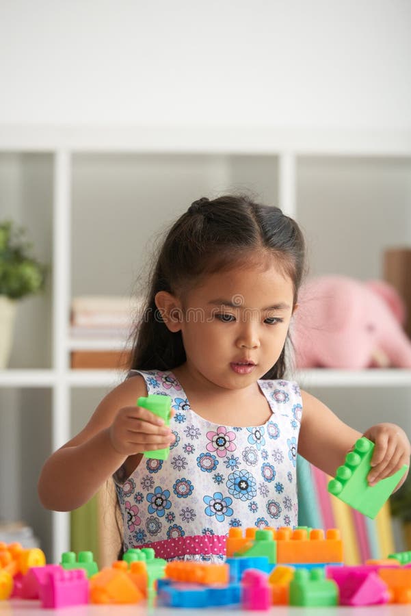 Girl playing with blocks stock photo. Image of construction - 121939576