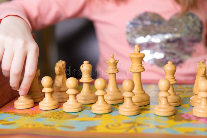 Little girl playing chess stock image. Image of playful - 245489513