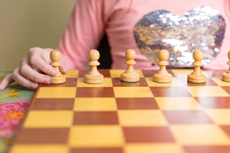Little girl playing chess stock photo. Image of home - 245489528