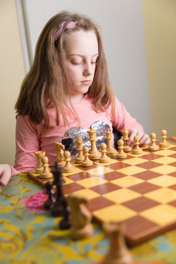 Little girl playing chess stock photo. Image of clever - 245489532