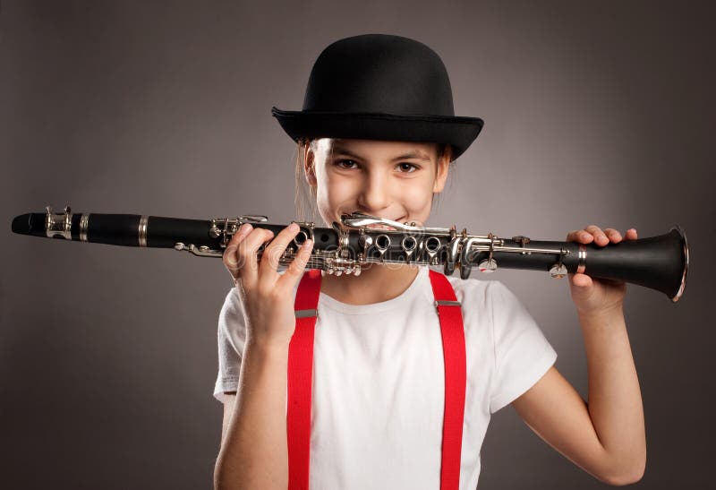 Little Girl Playing Clarinet Stock Image - Image of artist, bowler ...