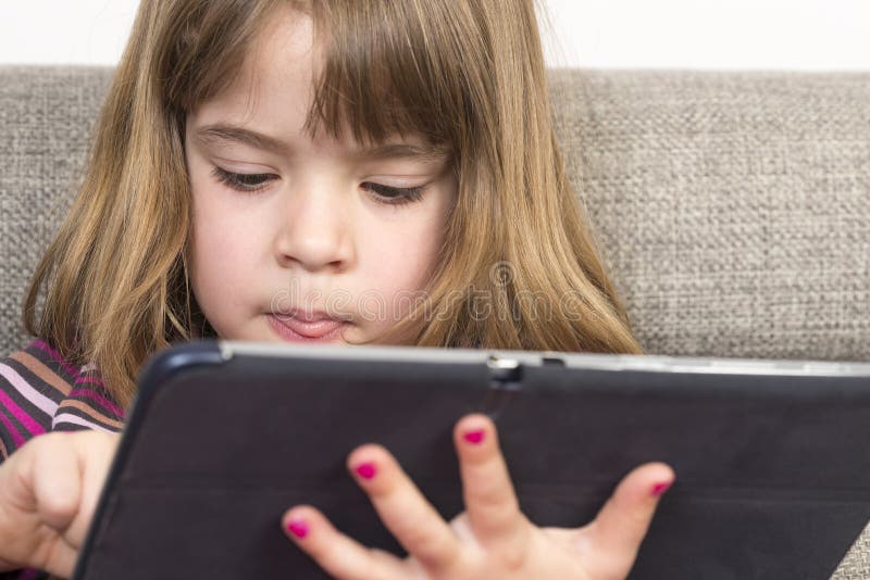 Little Girl Playing with a Digital Tablet Stock Photo - Image of device ...