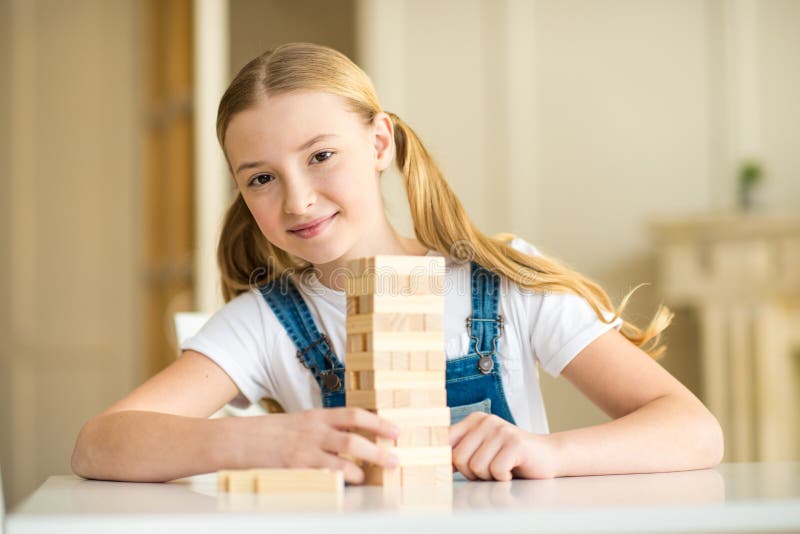 Little Girl Playing Jenga Game and Smiling at Camera Stock Image ...