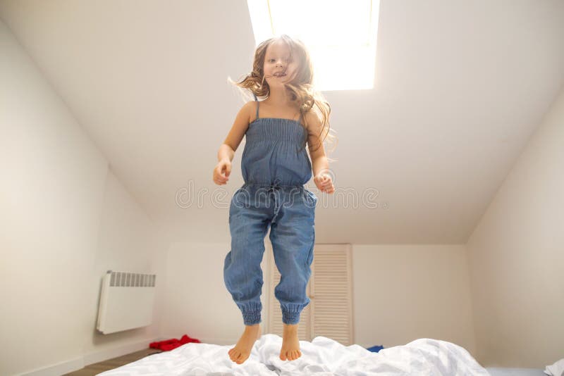 Little Girl Playing and Jumping at Home Stock Photo - Image of indoors ...