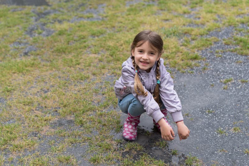 Little Girl Playing in the Rain Stock Image - Image of playing, jumping ...
