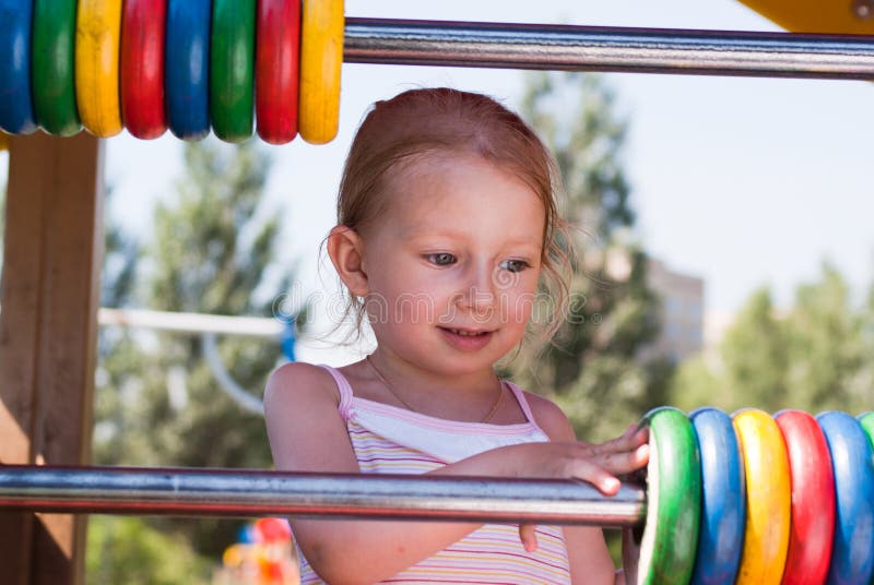 A Little Girl Playing with the Rings in the Park Stock Image - Image of ...