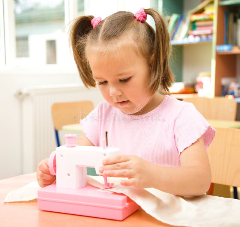 Little Girl is Playing with Sewing Machine Stock Image - Image of ...