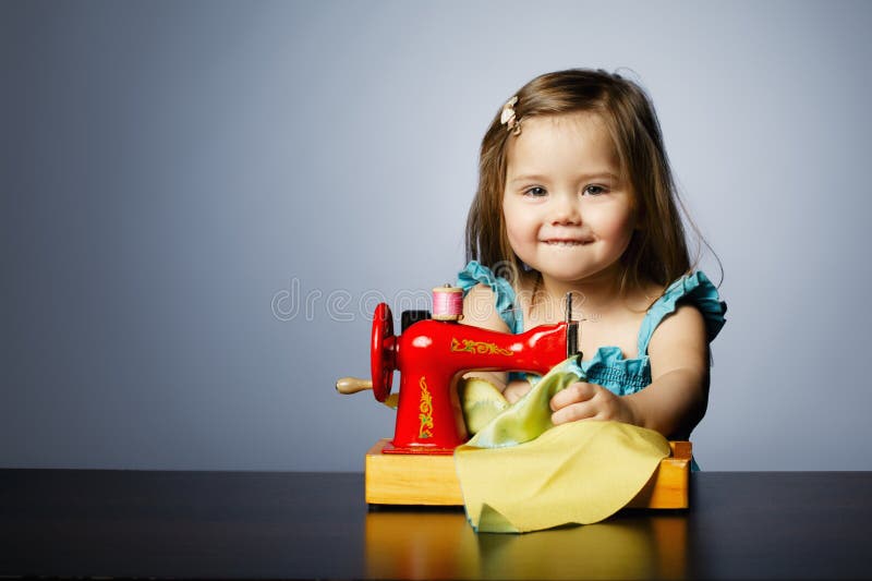 Little Girl is Playing with Sewing Machine Stock Image - Image of ...