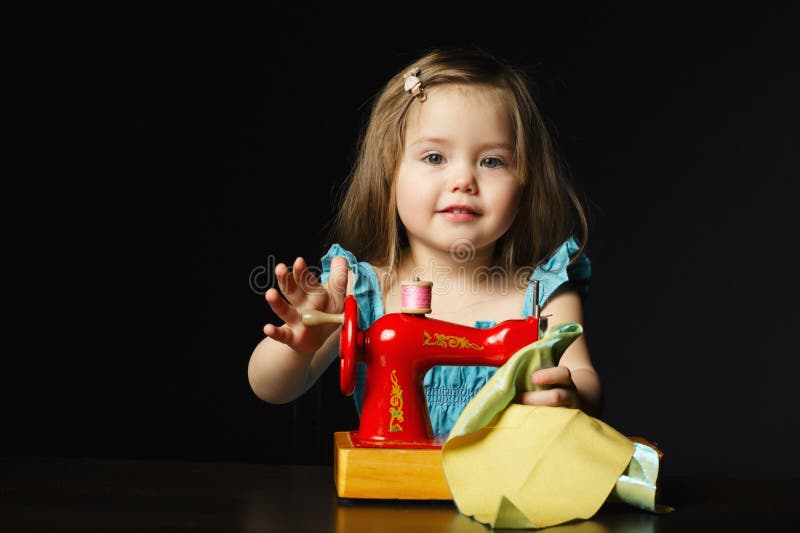 Little Girl is Playing with Sewing Machine Stock Image - Image of ...