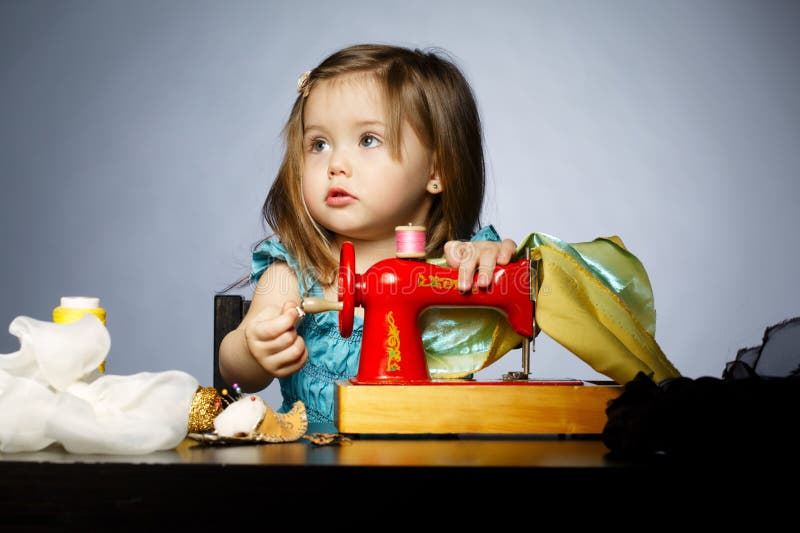 Little Girl is Playing with Sewing Machine Stock Photo - Image of ...