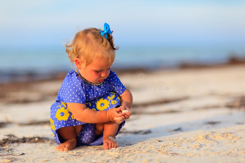 Little Girl Playing with Shells on the Beach Stock Photo - Image of ...