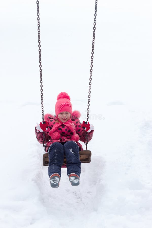 Little Girl Playing in a Snow Pile Stock Photo - Image of laughing ...