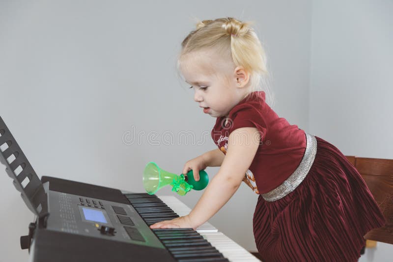 Little Girl Playing a Synthesizer Stock Photo - Image of person, child ...