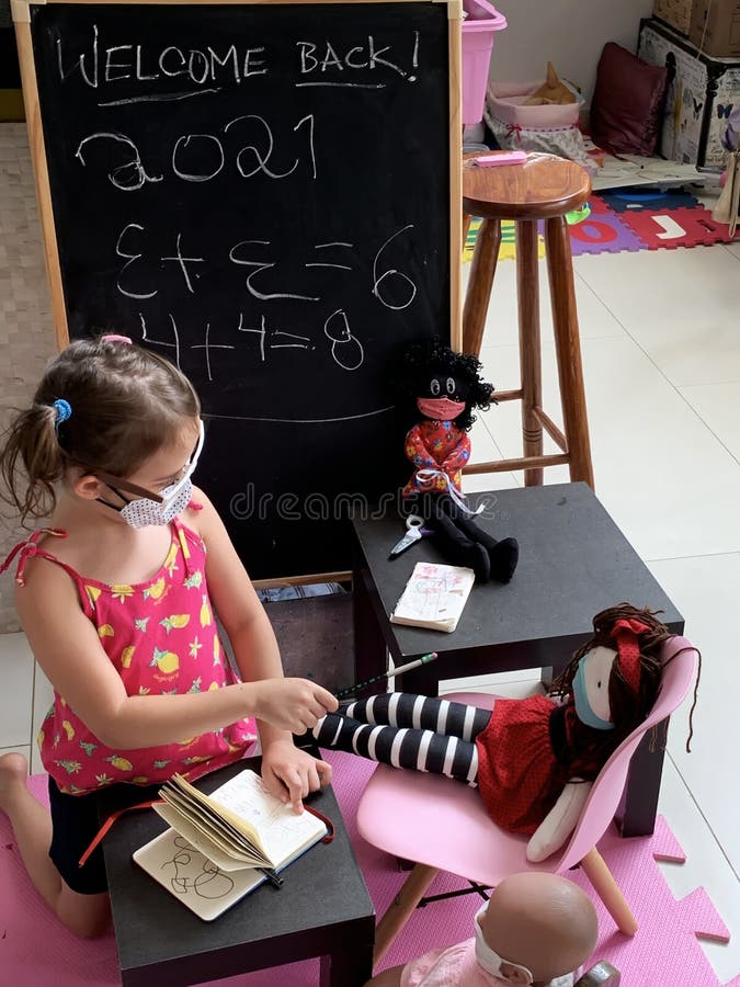 Little Girl Playing Teacher, Teaching Her Dolls with a Mask. Basic ...