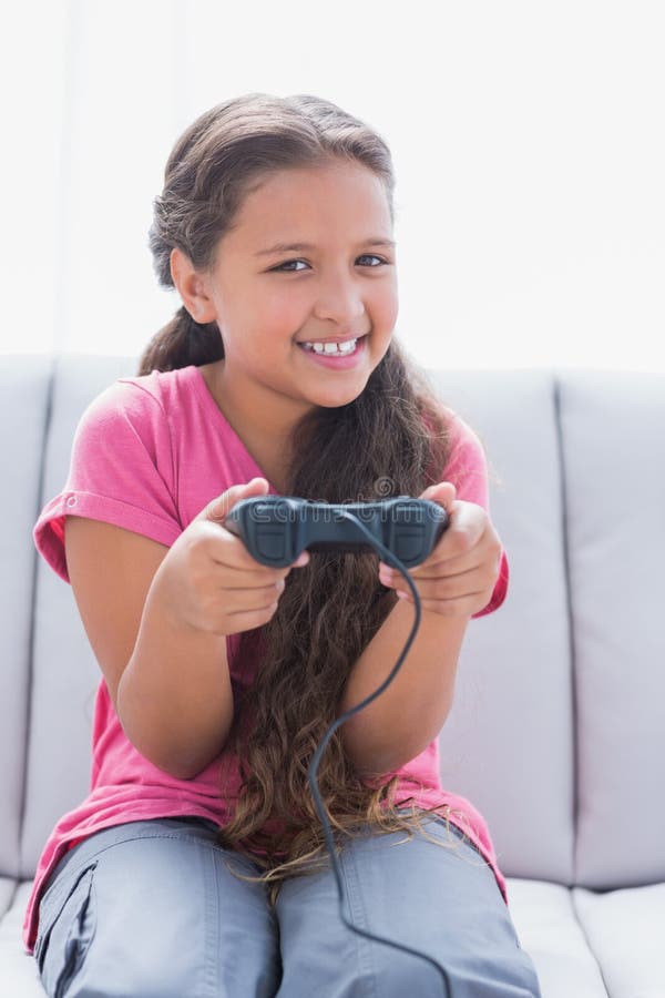 Little Girl Playing Video Game on Sofa Stock Photo - Image of ...