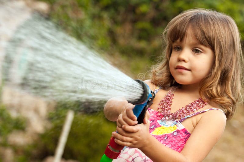 Little Girl Playing with Water Stock Photo - Image of sunny, playing ...
