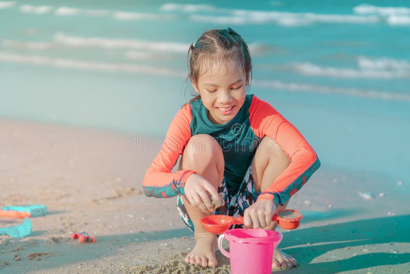 Little Girl Playing with Wave and Sand on the Beach Stock Image - Image ...