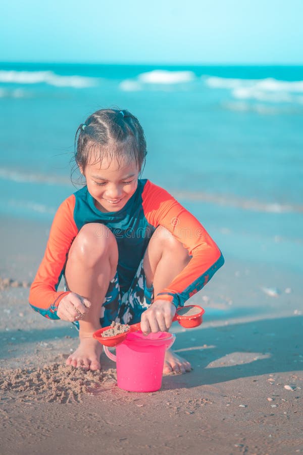 Little Girl Playing with Wave and Sand on the Beach Stock Image - Image ...