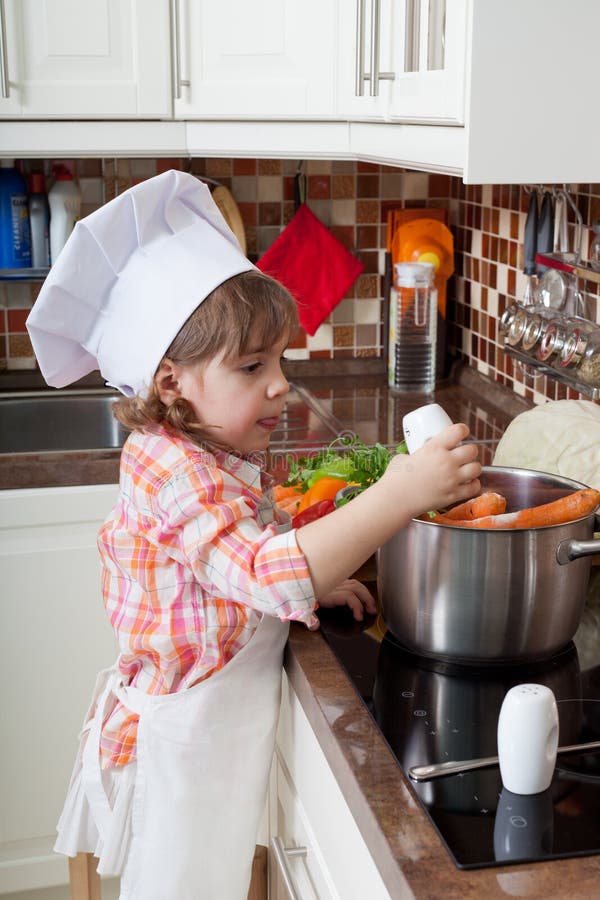 Little girl plays the cook stock image. Image of cook - 29011667