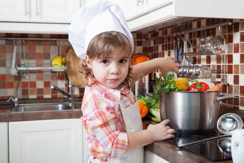 Little girl plays the cook stock image. Image of helps - 30965153
