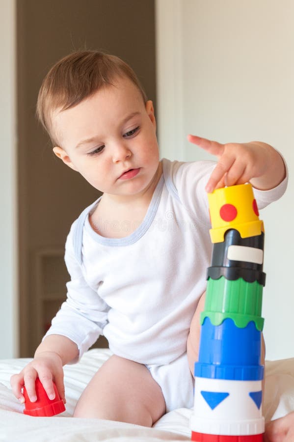 Little Girl Plays To Stack the Tower Stock Photo - Image of italia ...