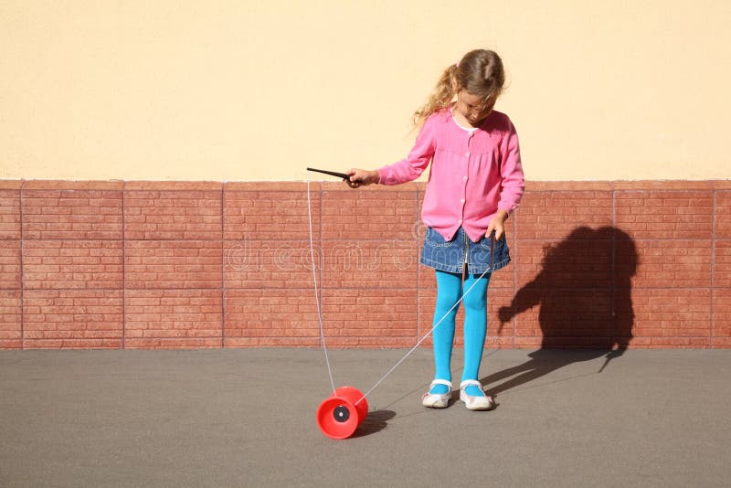 Little Girl Plays with Yo-yo Stock Photo - Image of happy, balance ...
