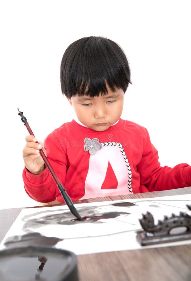 A Little Girl Practicing Calligraphy in Front of a White Background ...