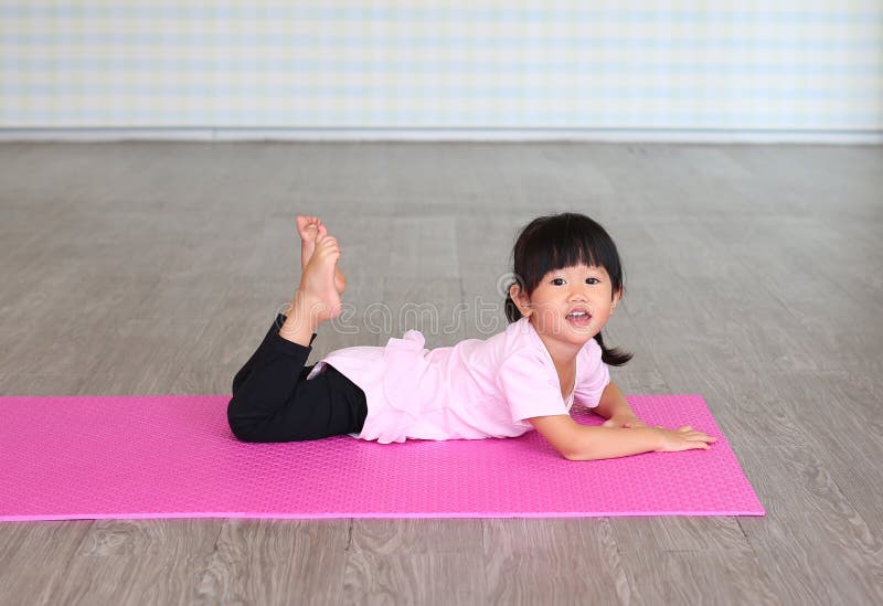 Little Girl Practicing Yoga or Exercise Stock Photo - Image of leisure ...