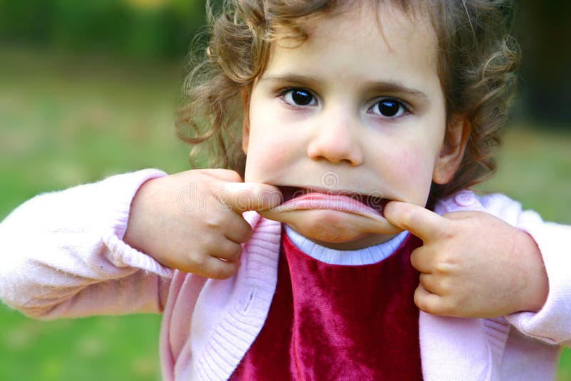 Little girl pulling faces stock photo. Image of expressive - 7766934